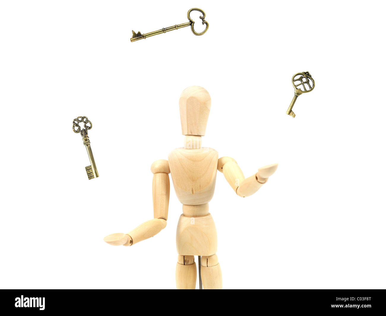 A manikin juggling keys on a white background Stock Photo - Alamy