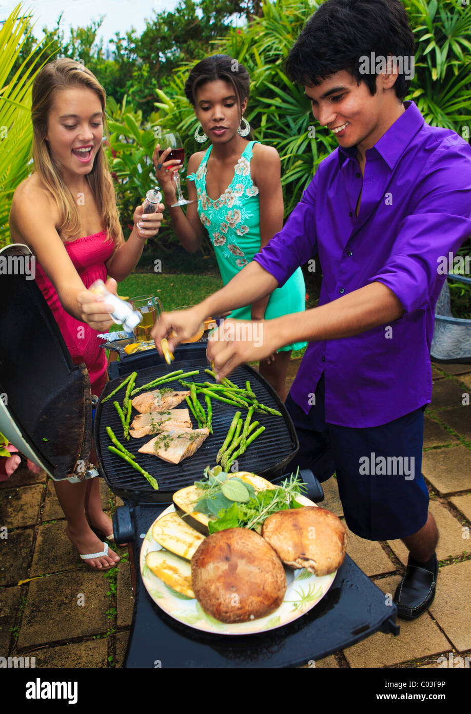 three friends at a barbecue party in hawaii Stock Photo - Alamy