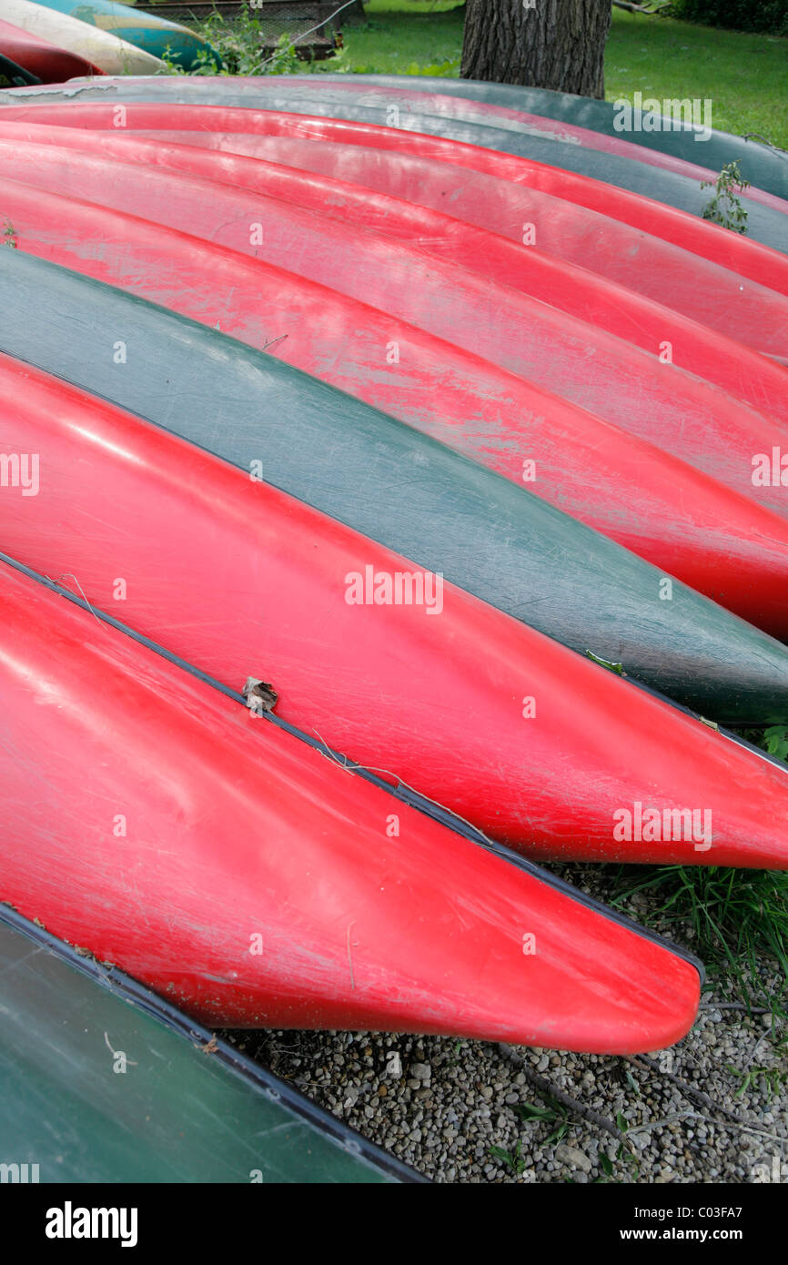 Canoes line up on land in preparation for use on a river trip Stock ...