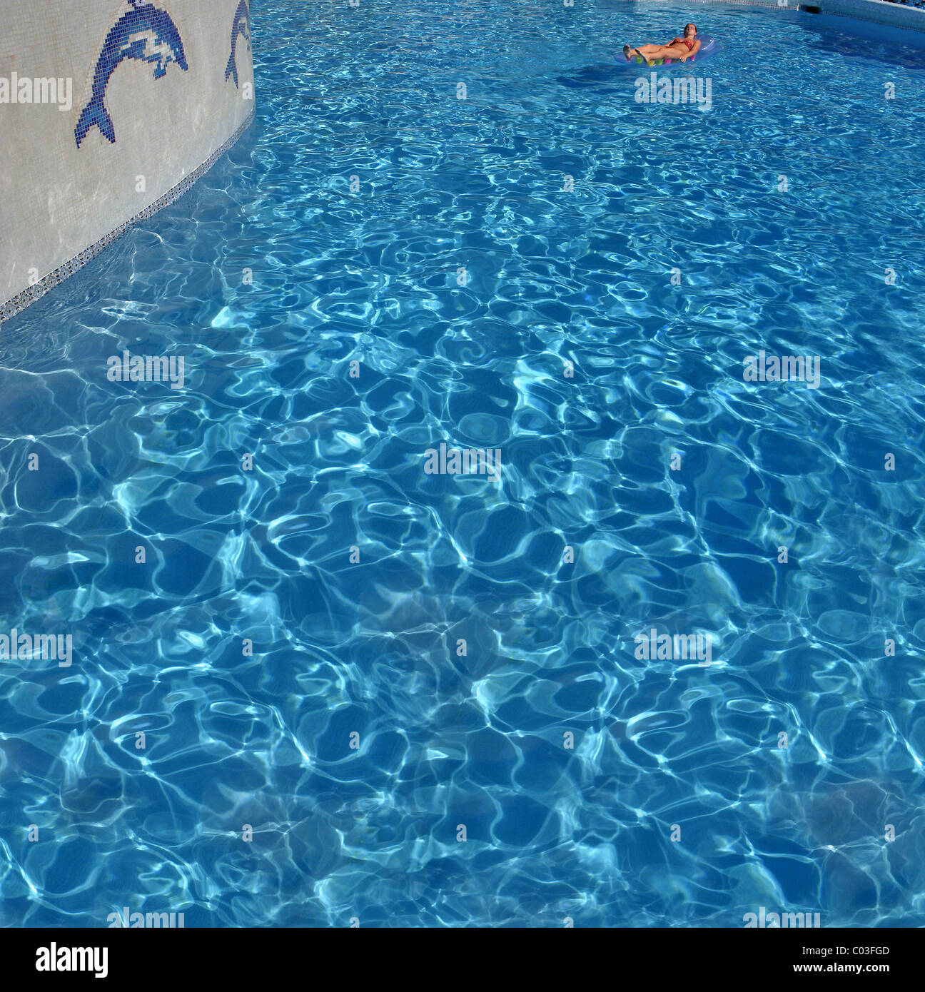 swimming pool with a woman on airbed Stock Photo - Alamy