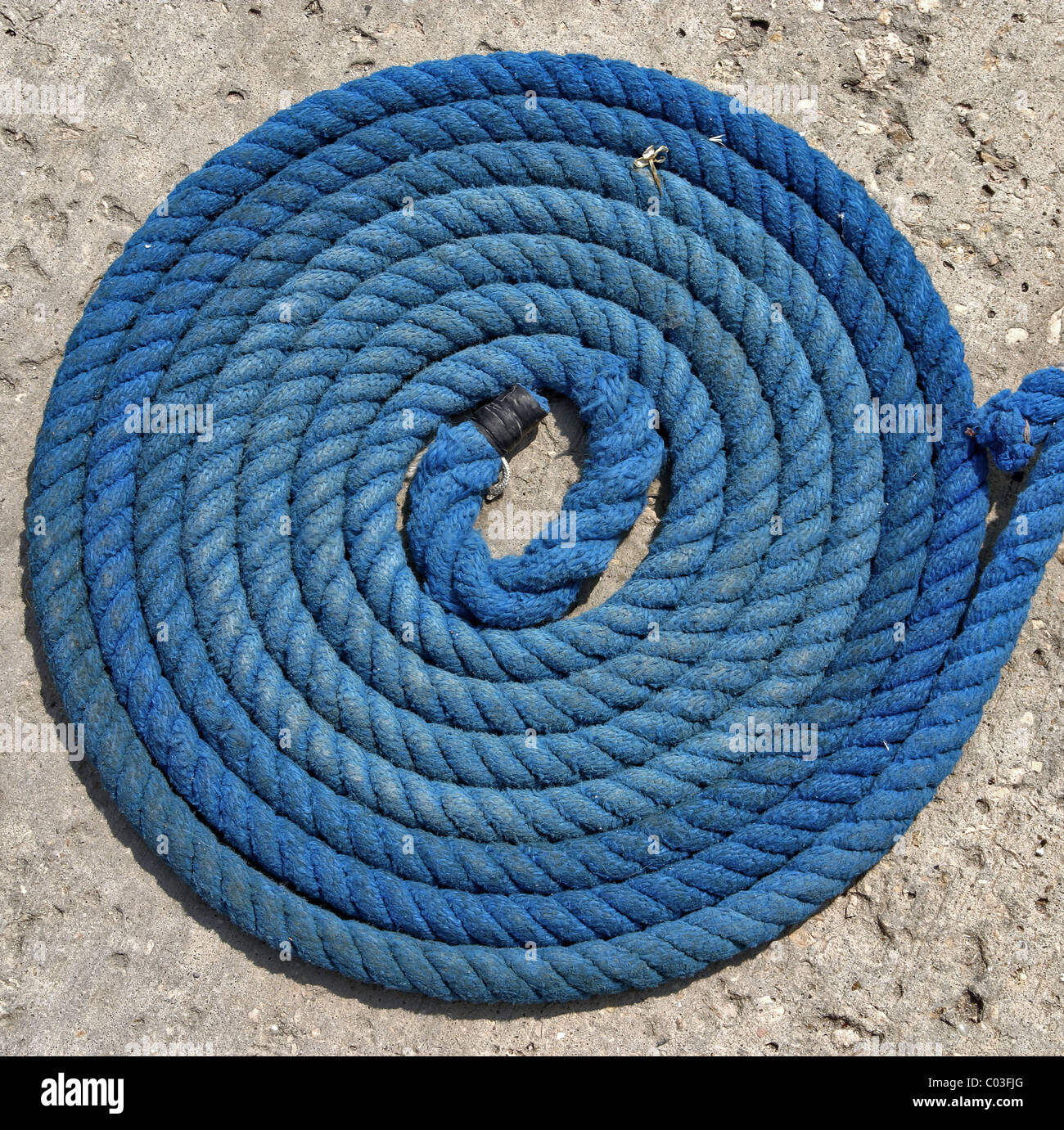 blue rope coiled at pier Stock Photo - Alamy