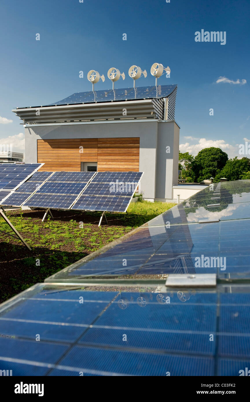 Solar panels and mini wind turbines on the roof of a hotel in Freiburg ...