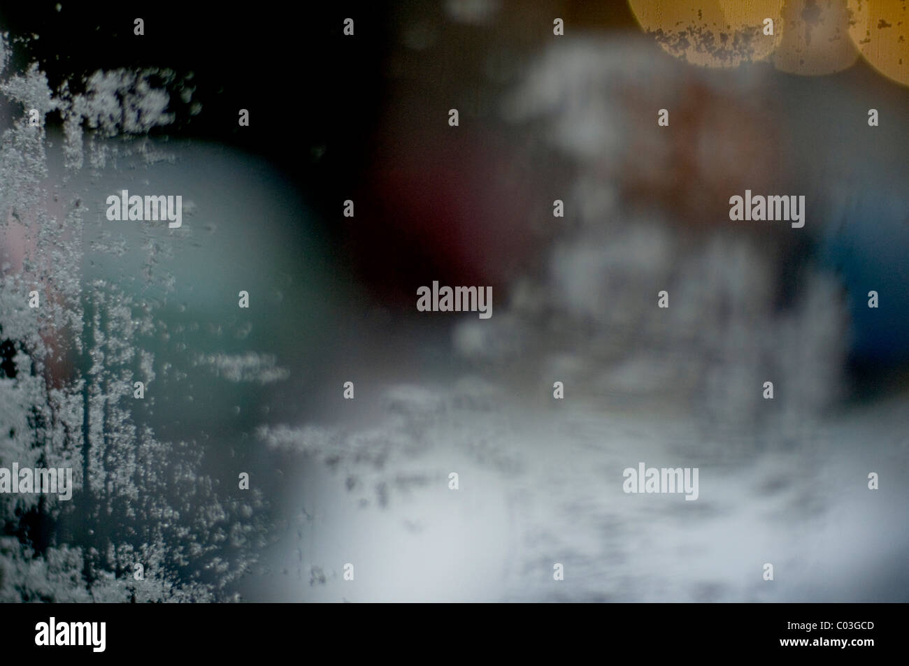 Colourful reflections through an icy window pane Stock Photo - Alamy