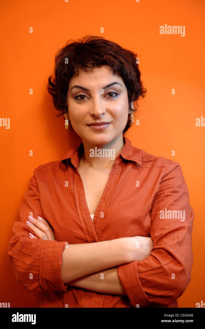 Portrait of a beautiful woman on orange background Stock Photo - Alamy