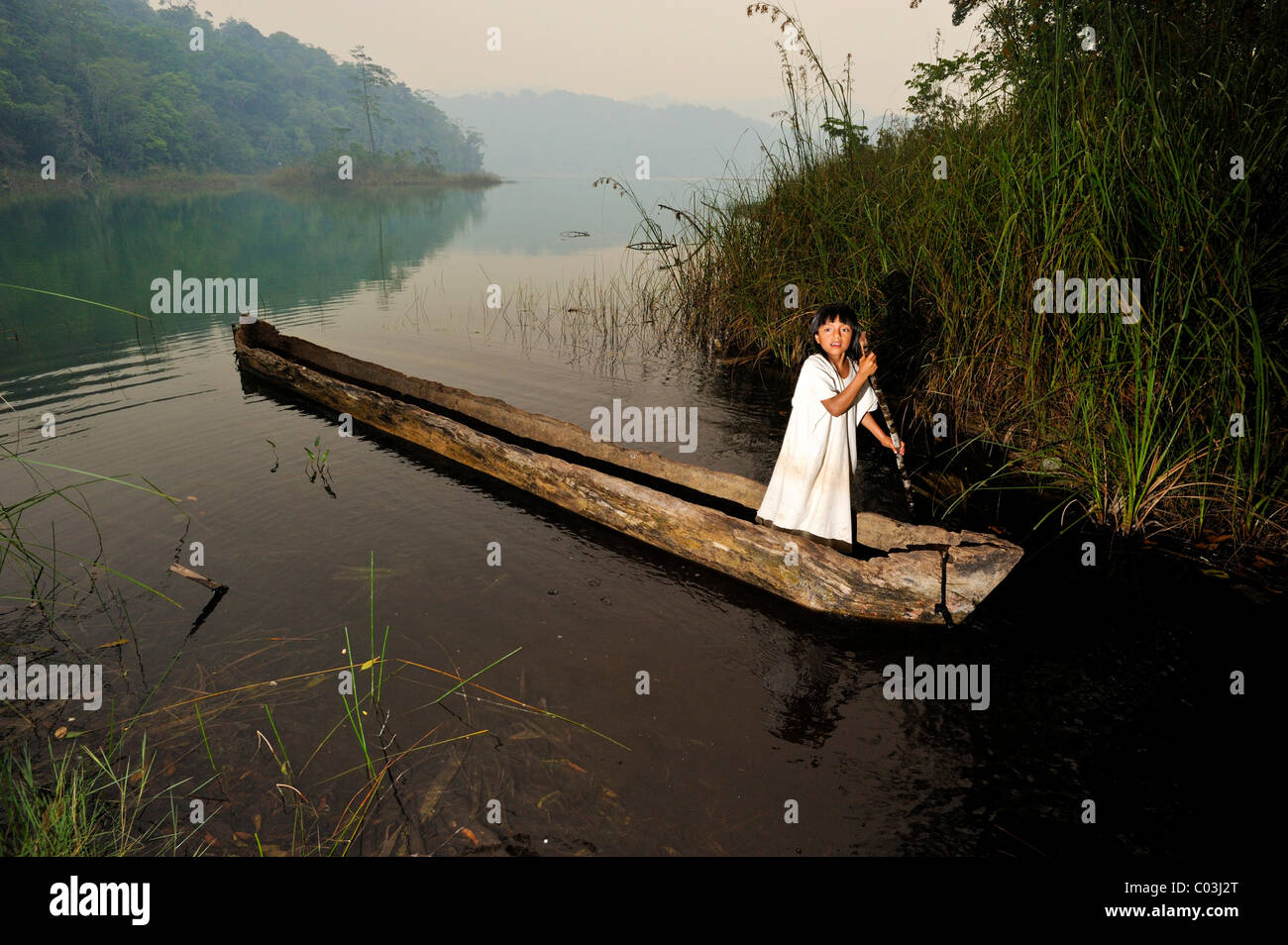 Child of the Lacandon Maya in the rainforest of Chiapas, on a boat on a ...