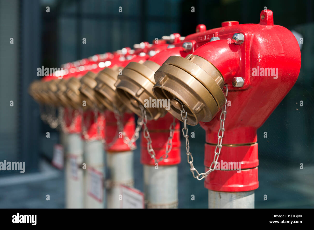 A number of fire water lines in front of a building Stock Photo - Alamy
