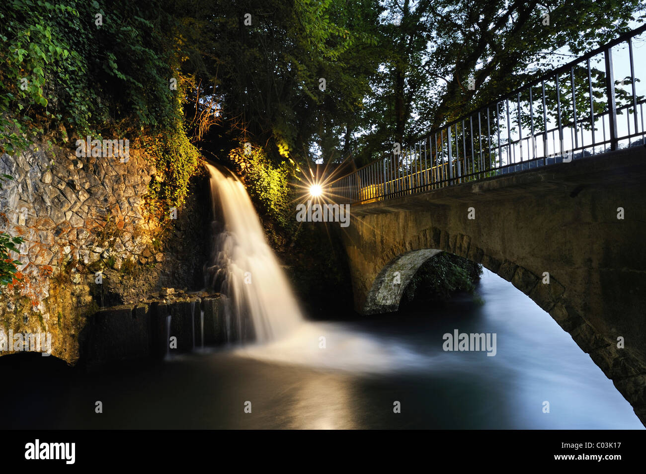 Small illuminated waterfall at the outflow channel of the power station ...