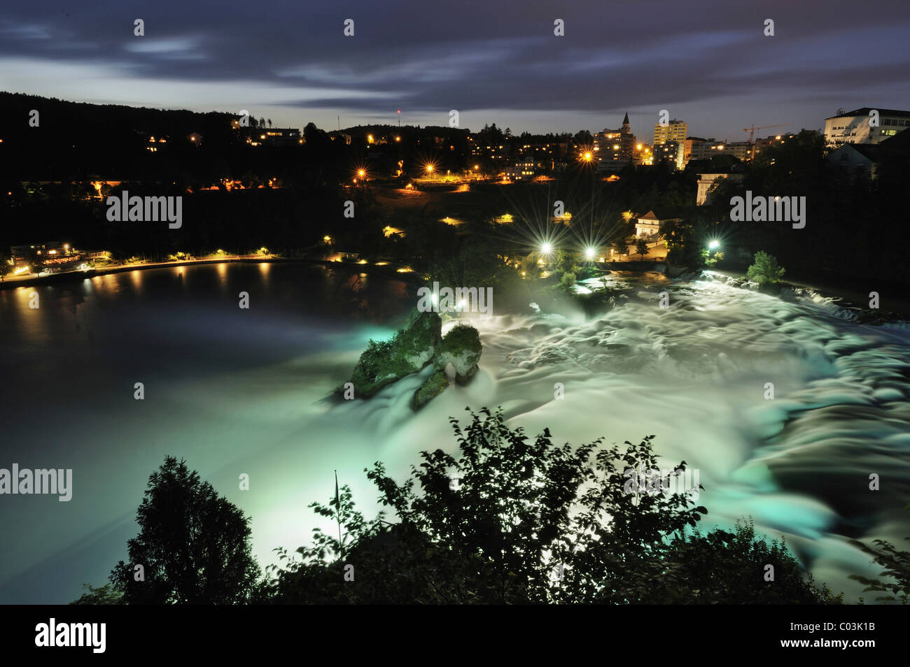 View from Schloss Laufen castle on the illuminated Rheinfall waterfalls ...