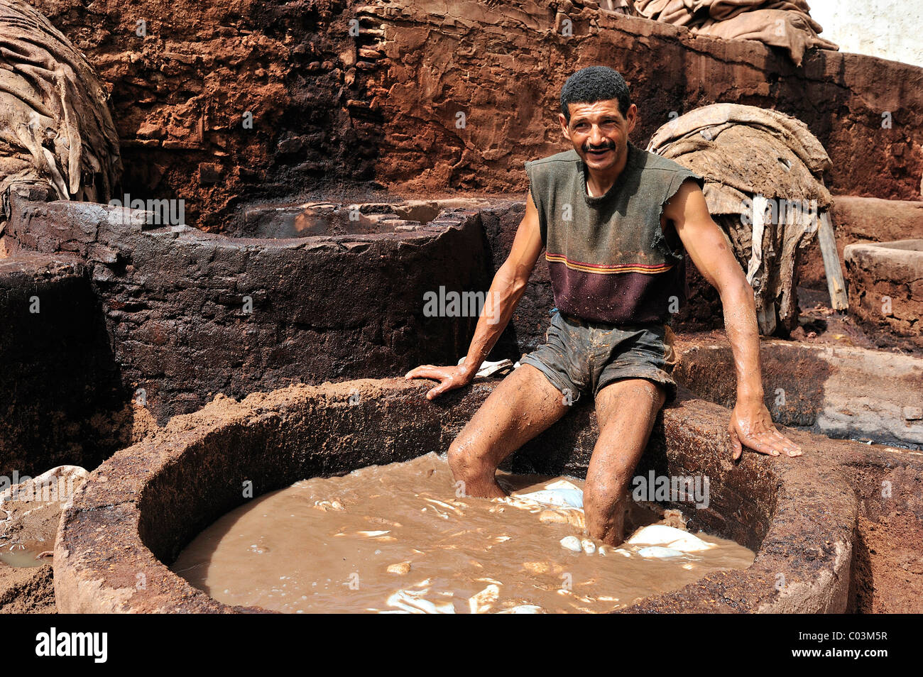 Worker in one of the vats used for tanning leather, tanners and dyers ...
