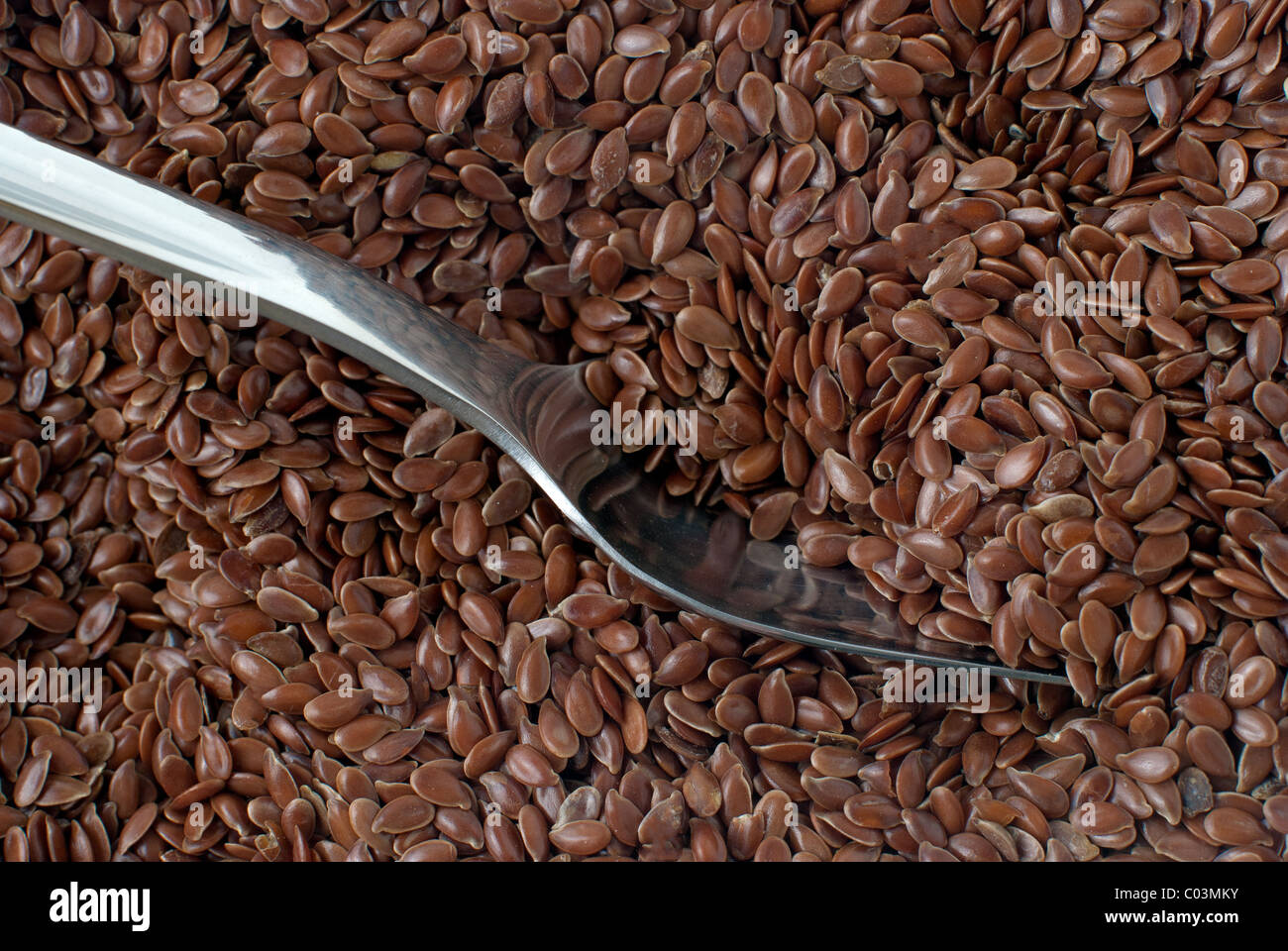 Linseed and a spoon detailed background Stock Photo - Alamy