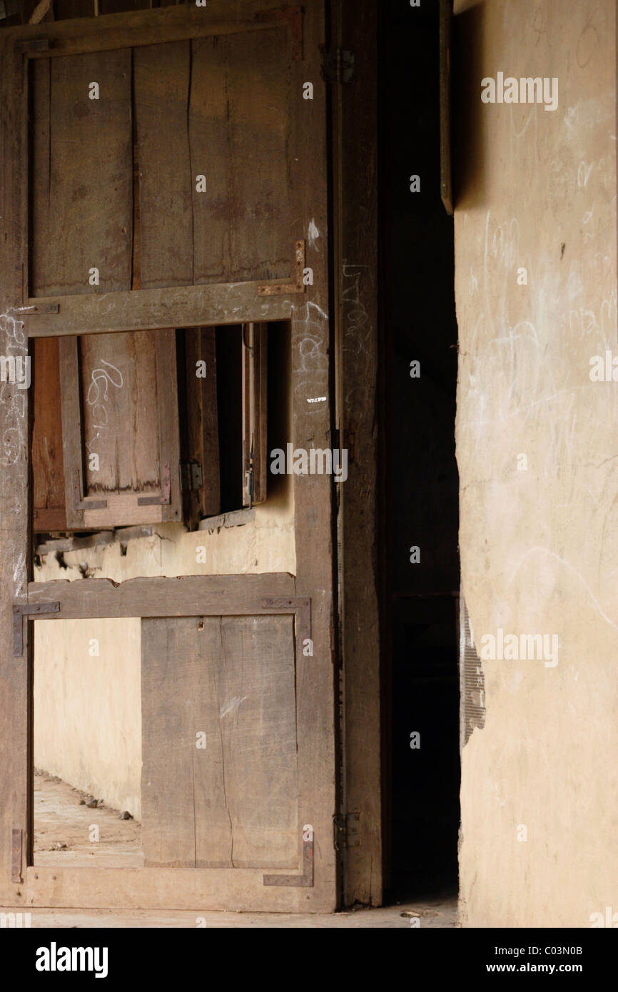 A broken wooden classroom door is left open at the end of the day at a ...