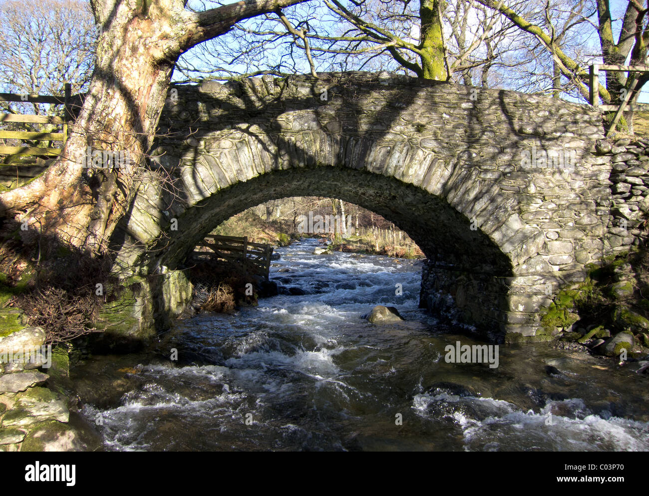 A small stone bridge spans a stream running into the river Greta ...