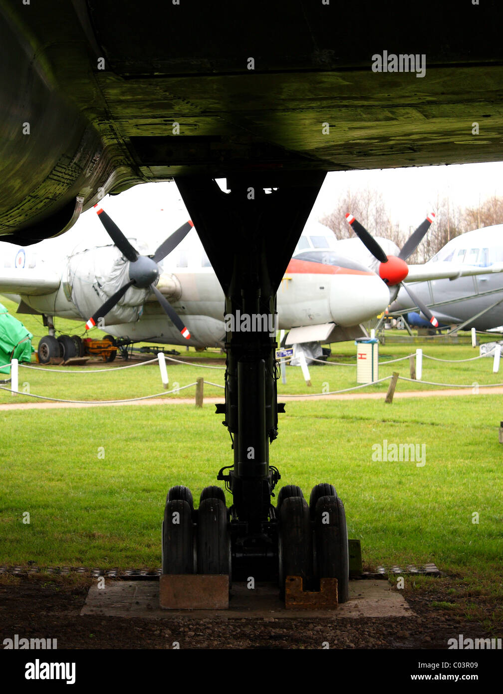 A landing wheel of an airplane with chocks. The plane is stationery ...