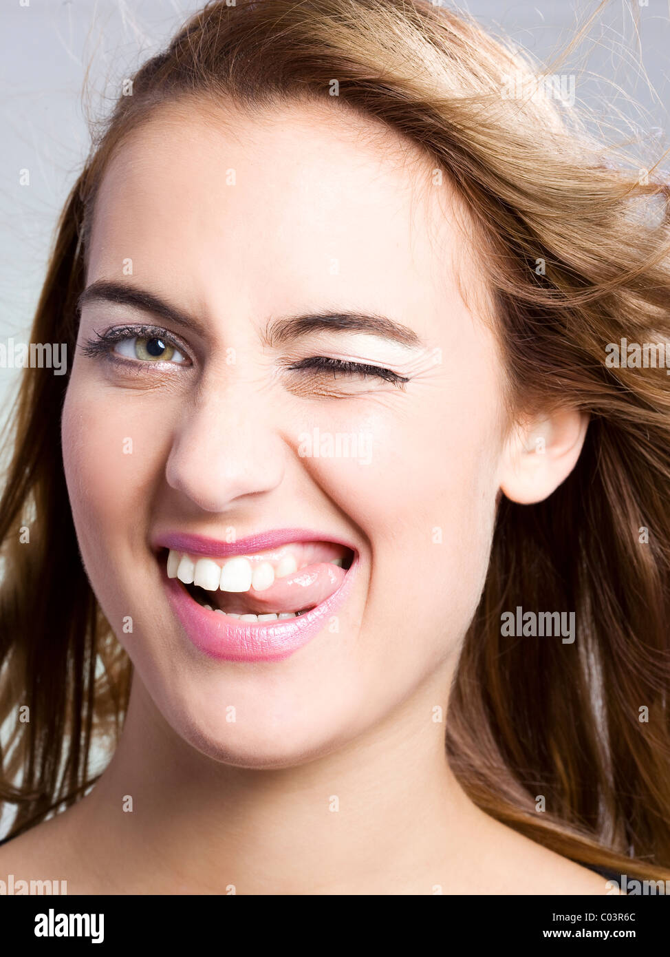 friendly young woman making a funny expression Stock Photo - Alamy
