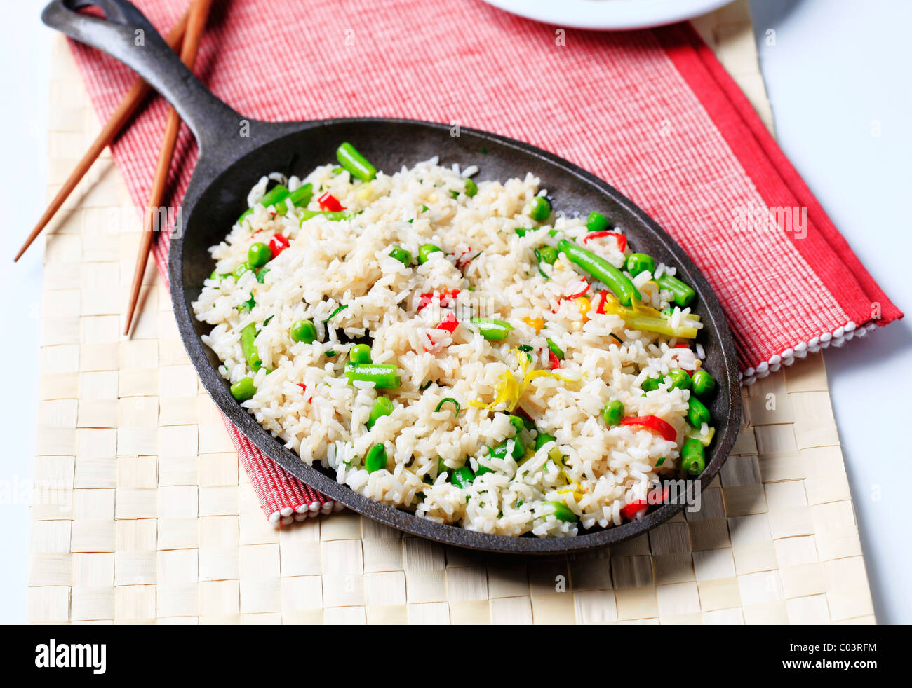 Fried rice in a black skillet - overhead Stock Photo - Alamy