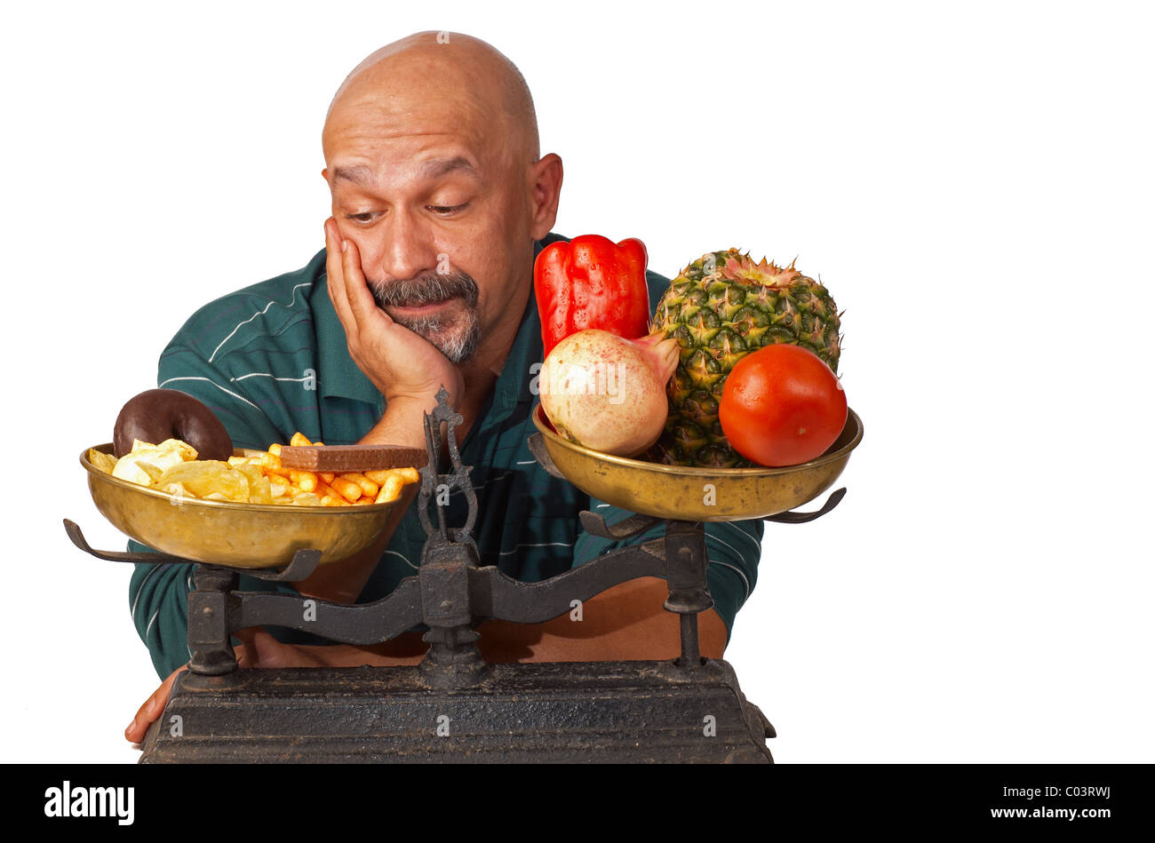 Guy on a diet anxiously looking at his favorite junk food Stock Photo ...
