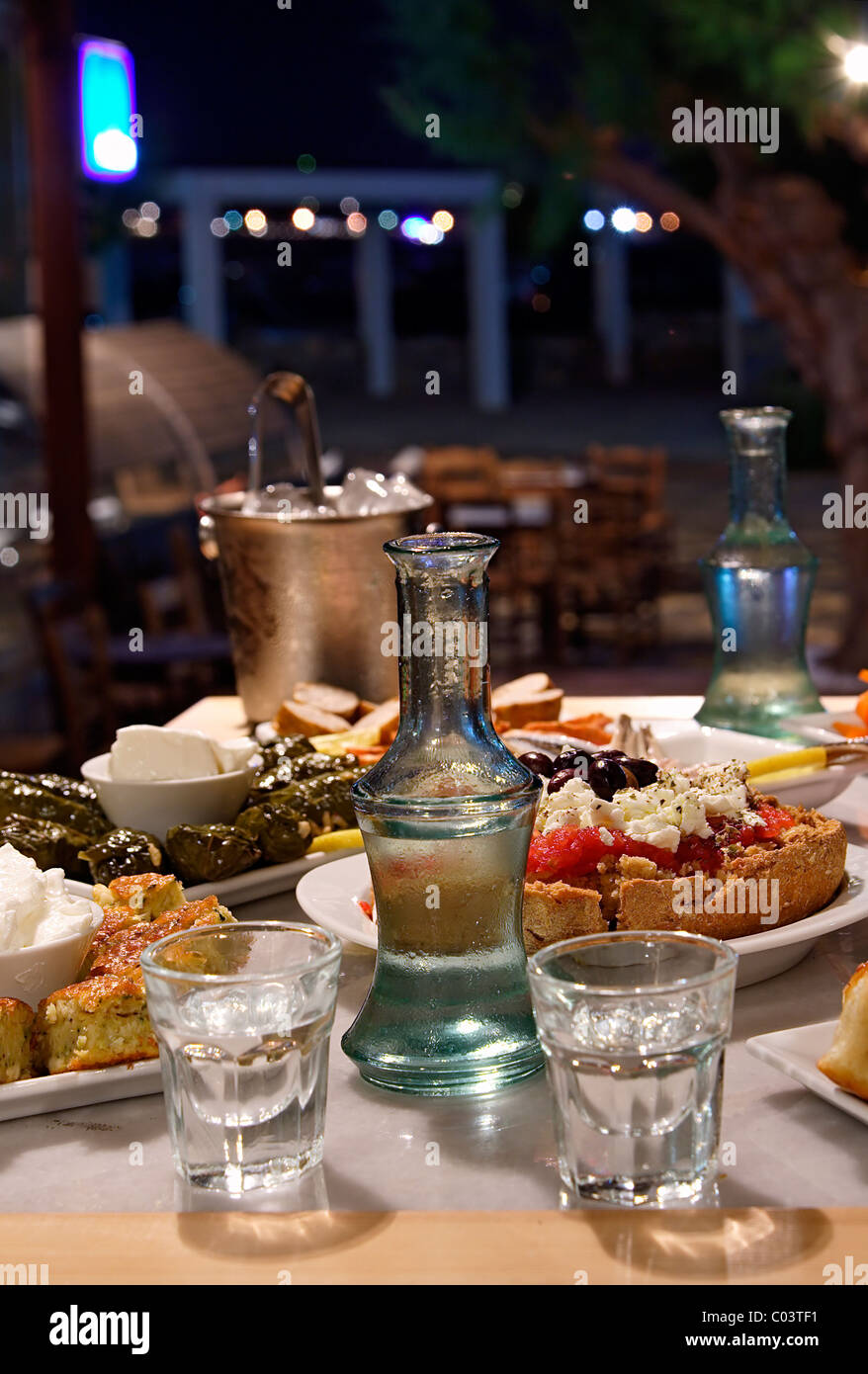 Table with traditional Cretan food and raki, the traditional Cretan ...