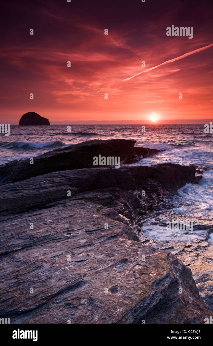 Sunset looking over rocks on the beach at Trebarwith Strand in Cornwall ...