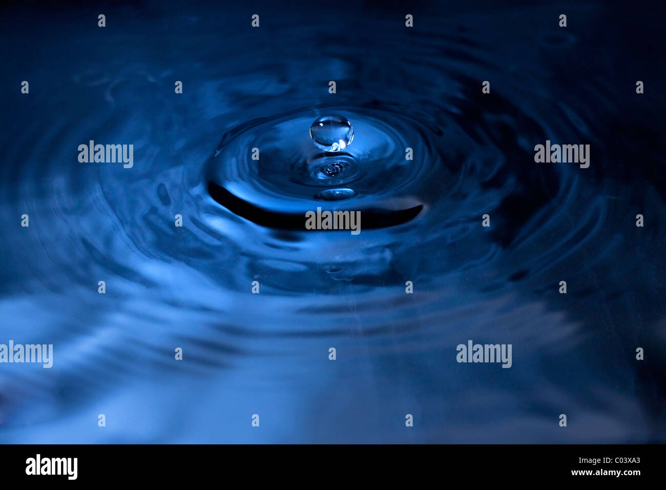 A water drop falling in water Stock Photo - Alamy