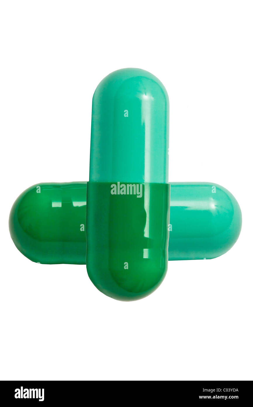Green capsules isolated on white background Stock Photo - Alamy