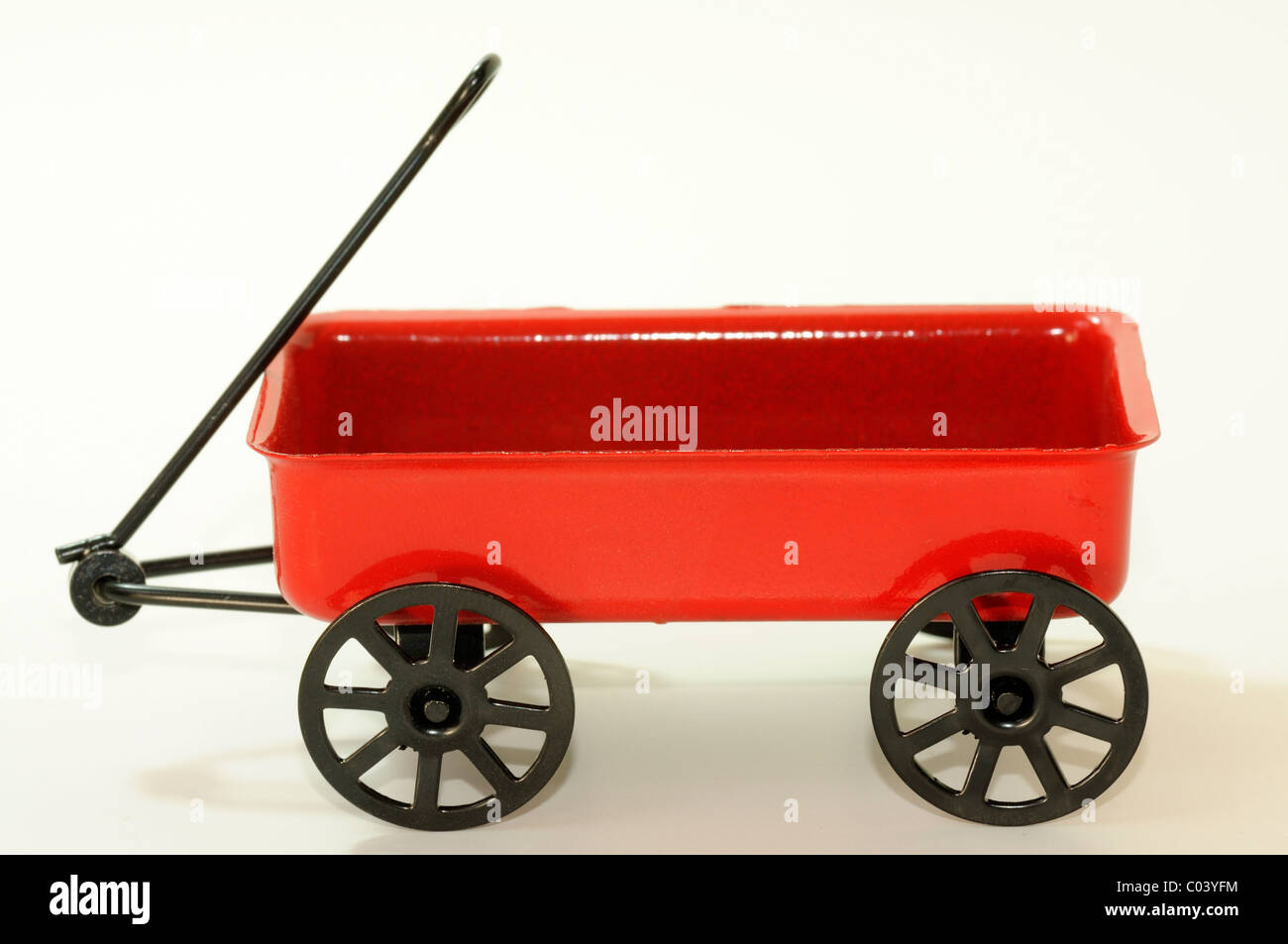 Miniature toy red wagon on a white background Stock Photo - Alamy
