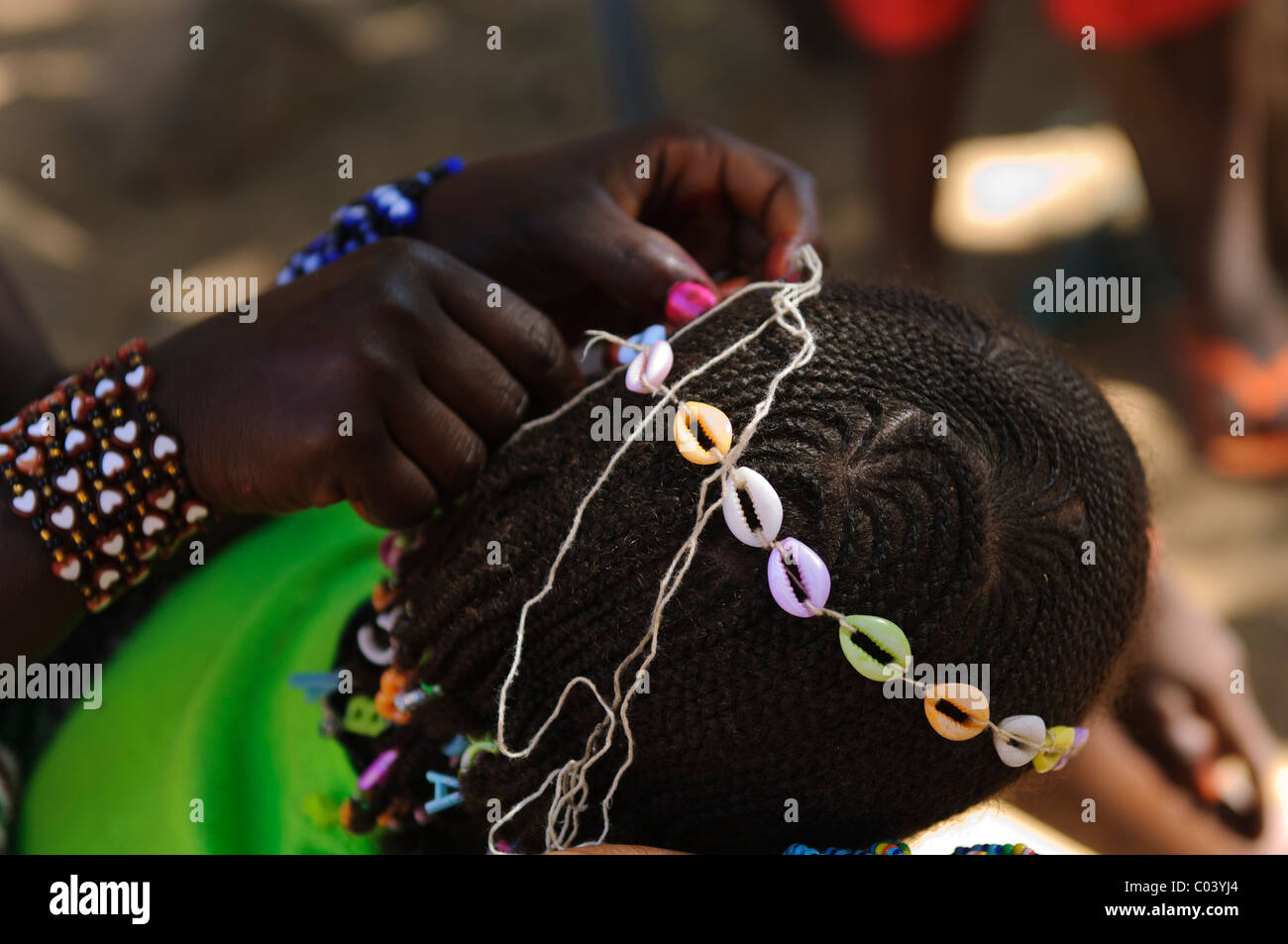 Teenage girls adorning each others hair for the Muslim festival of ...