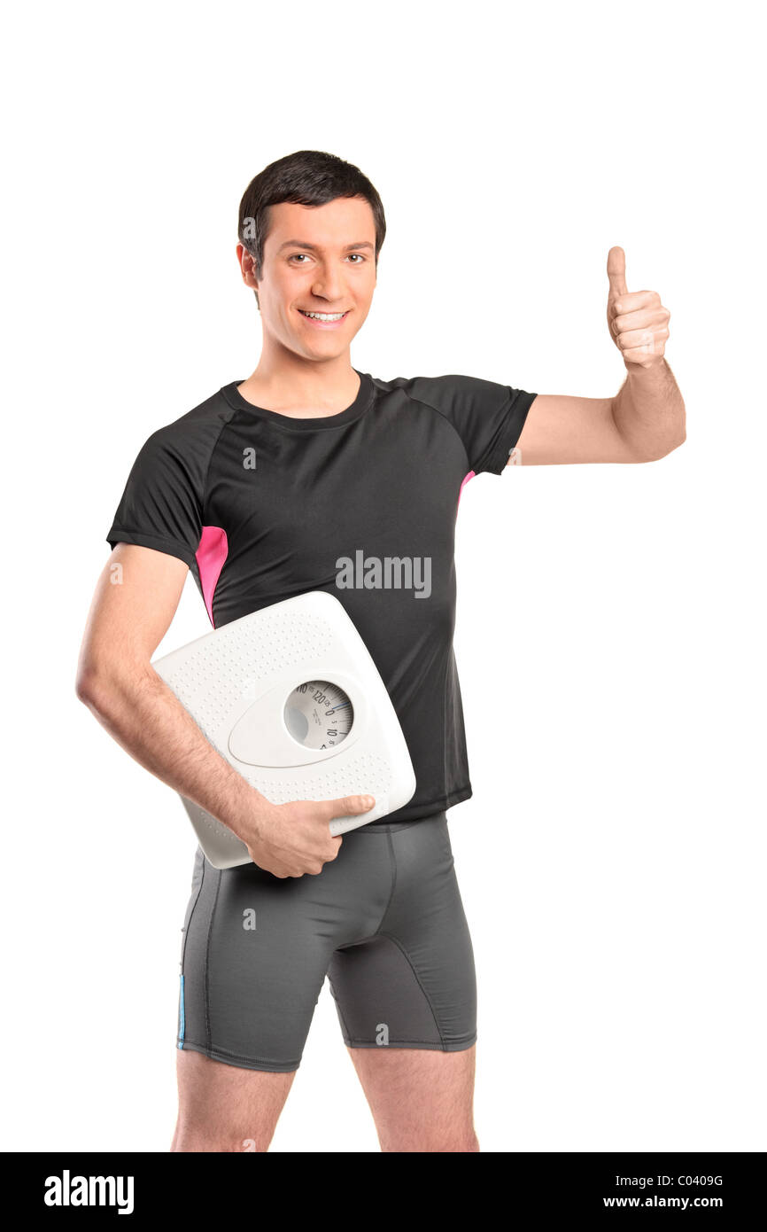 A happy young athlete holding a weight scale and giving thumb up Stock ...