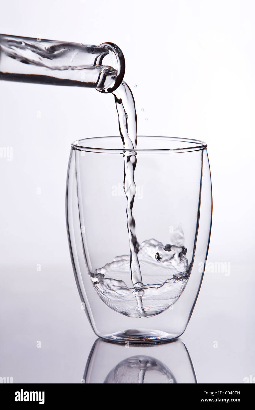 Shot of water falling into a glass Stock Photo - Alamy