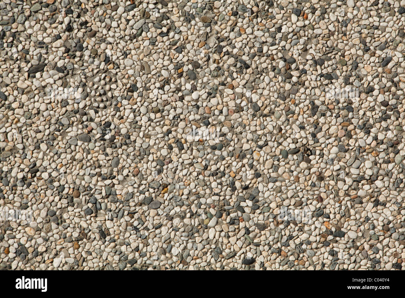A Rock Wall Background with small pebbles Stock Photo - Alamy