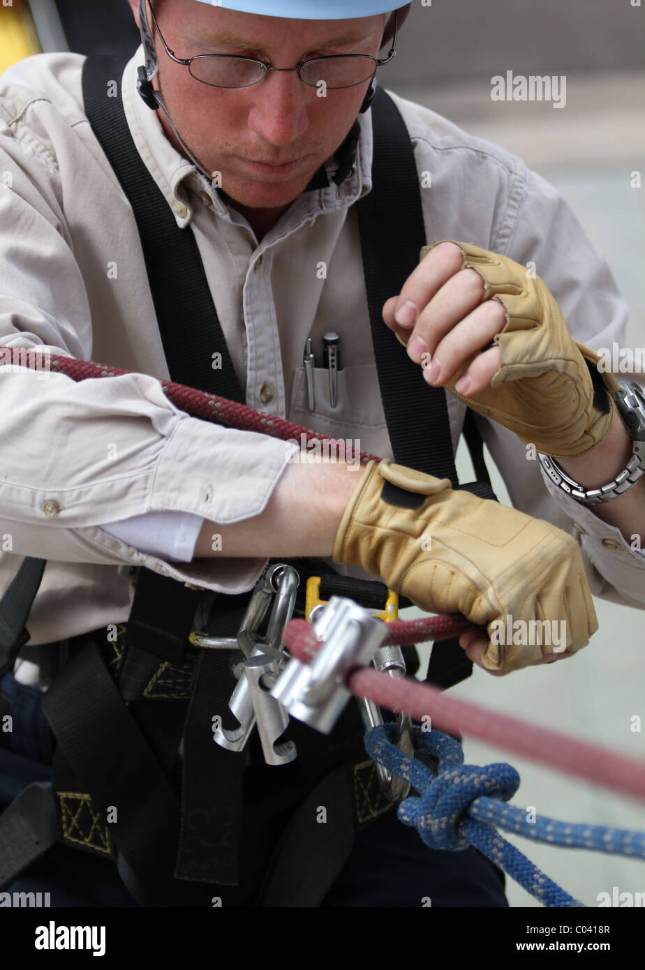 Young male learning how to use rope rescue equipment Stock Photo - Alamy