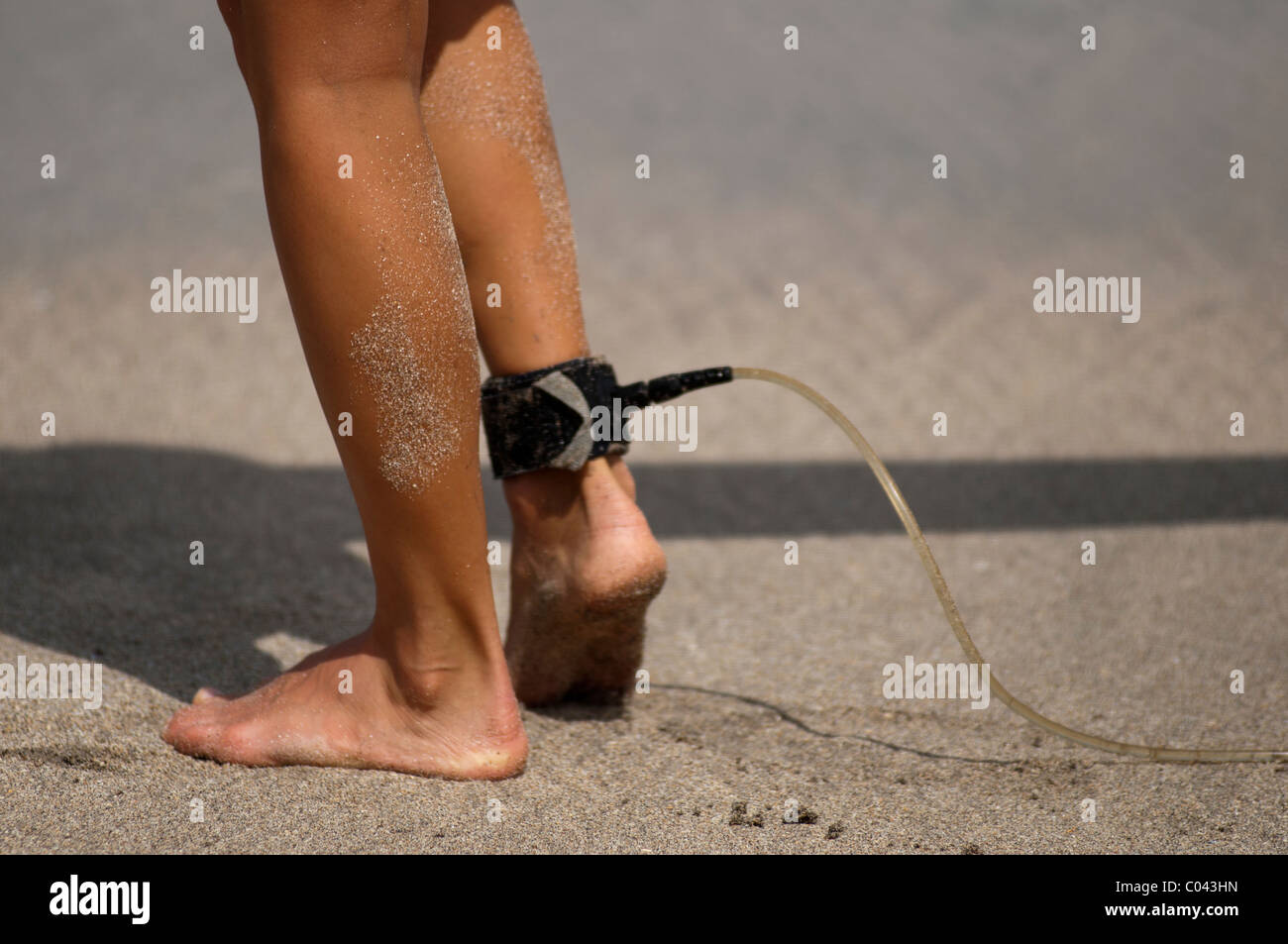 Legs of surfer with rope in Kuta Beach Stock Photo - Alamy