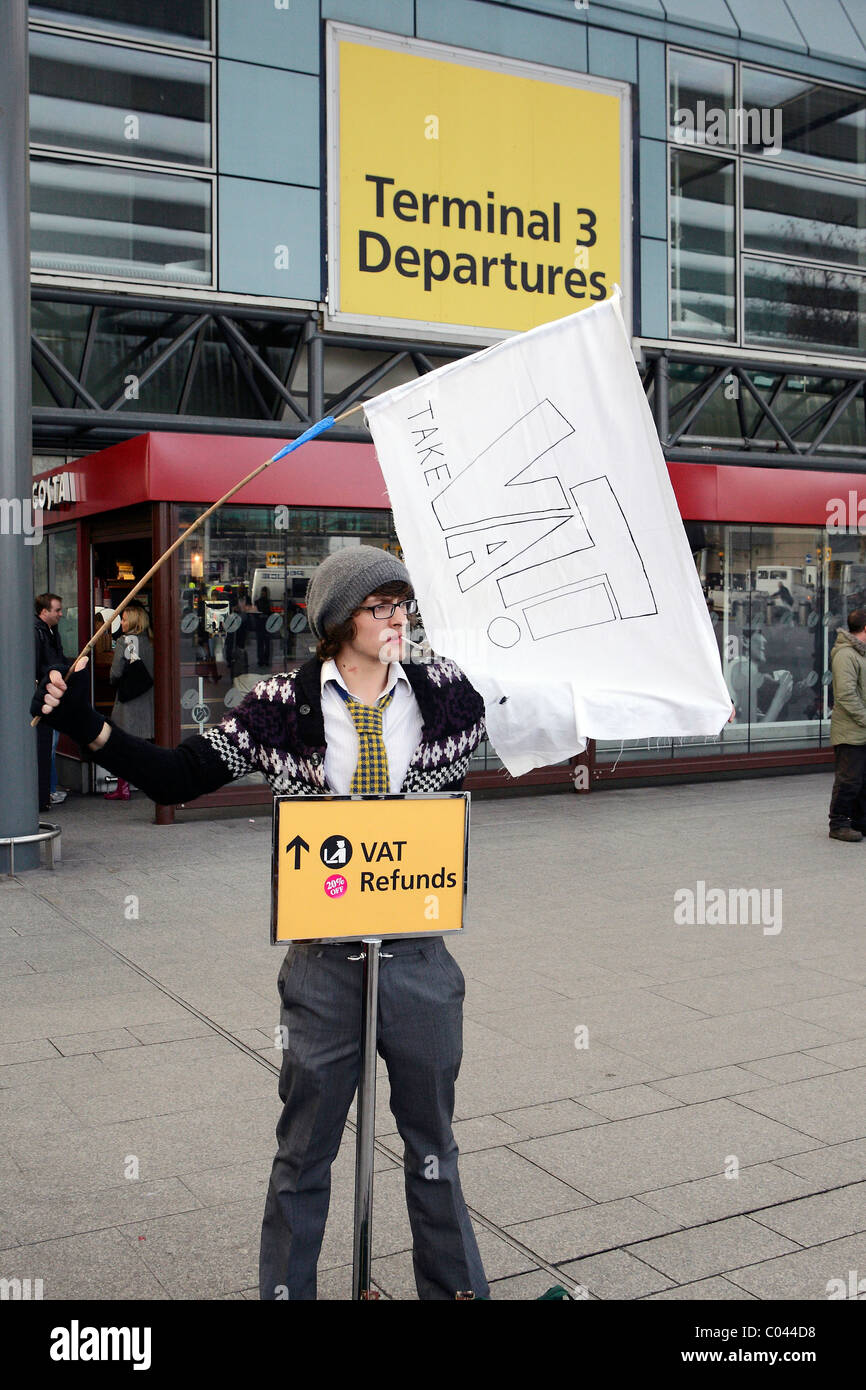 Take VAT protester poses in front of Terminal 3 at Heathrow Airport ...