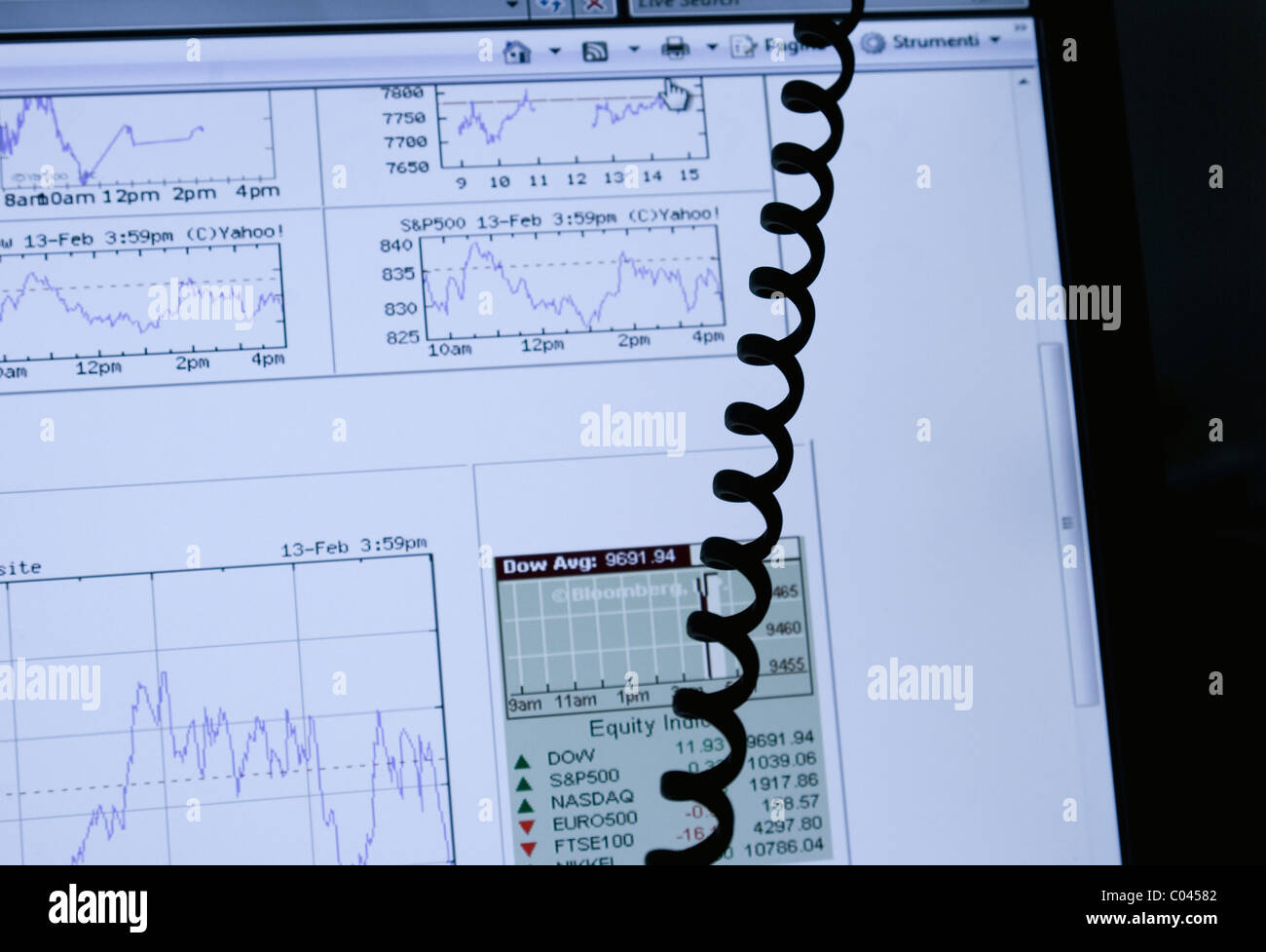 computer with stock exchange charts and phone cable Stock Photo - Alamy