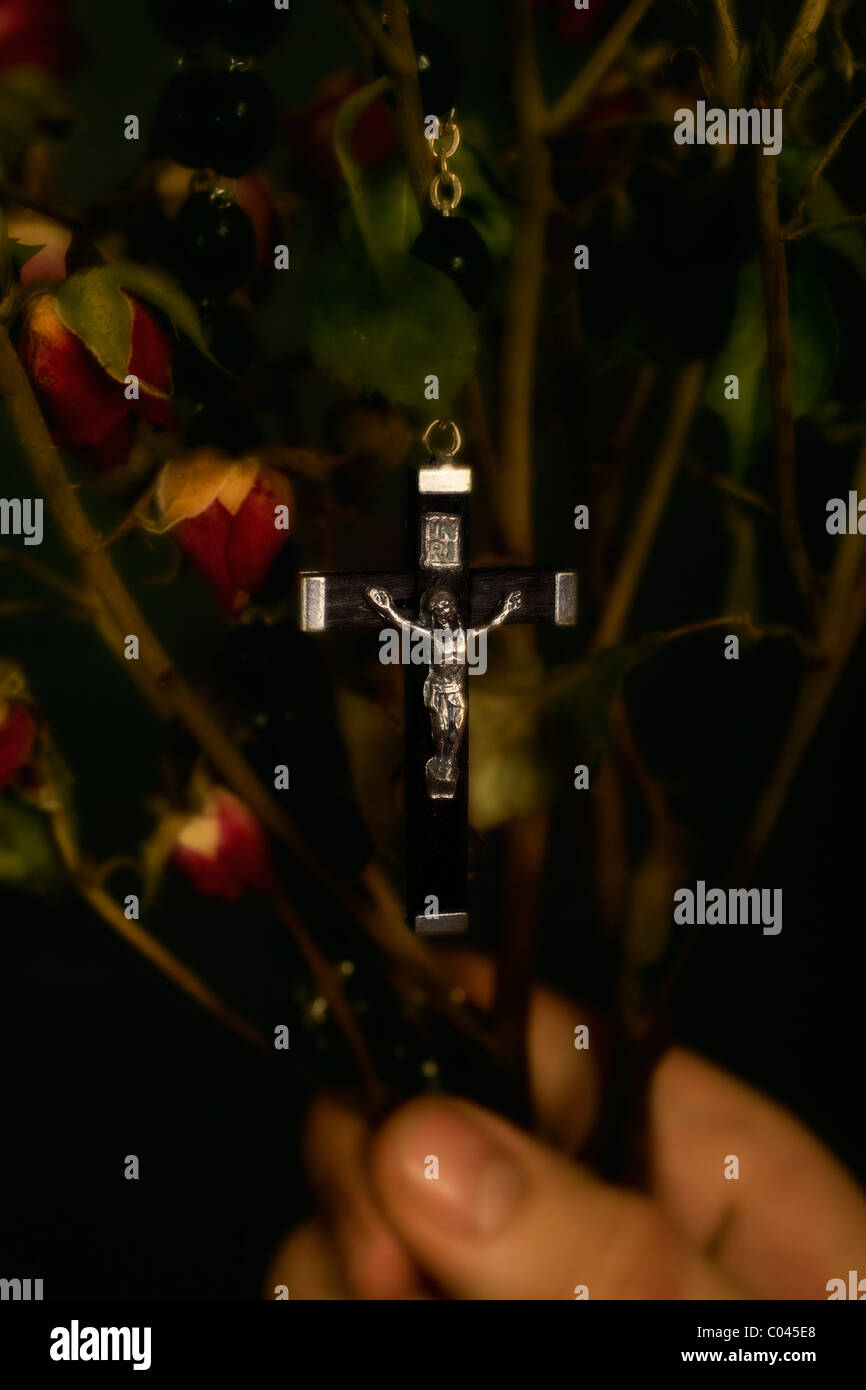 Catholic crucifix with dried roses closeup Stock Photo - Alamy