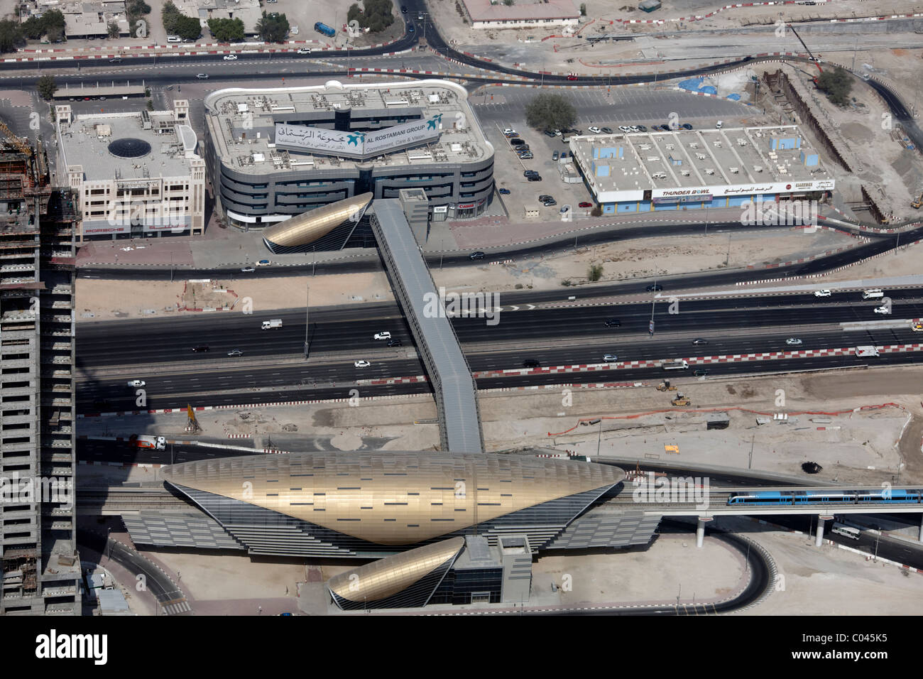 An 'armadillo' station of the Dubai metro, train departing Stock Photo ...