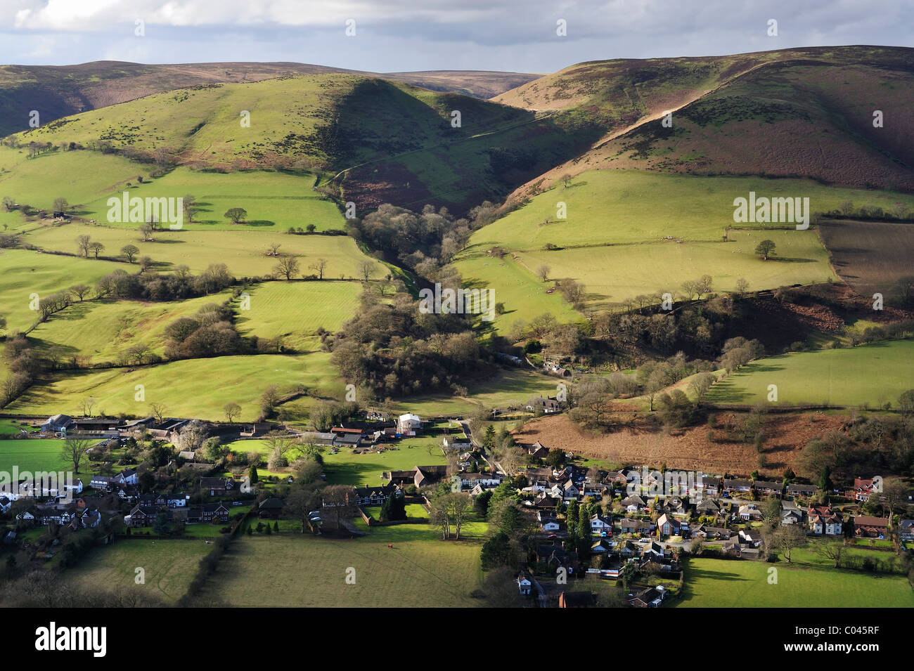 The village of Little Stretton with the Long Mynd Hills in the ...