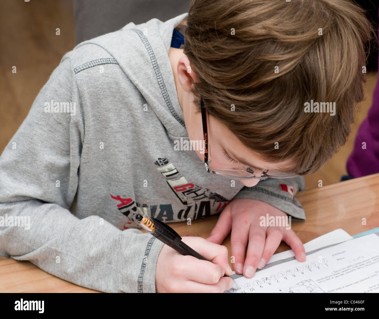 A young boy doing his homework Stock Photo - Alamy