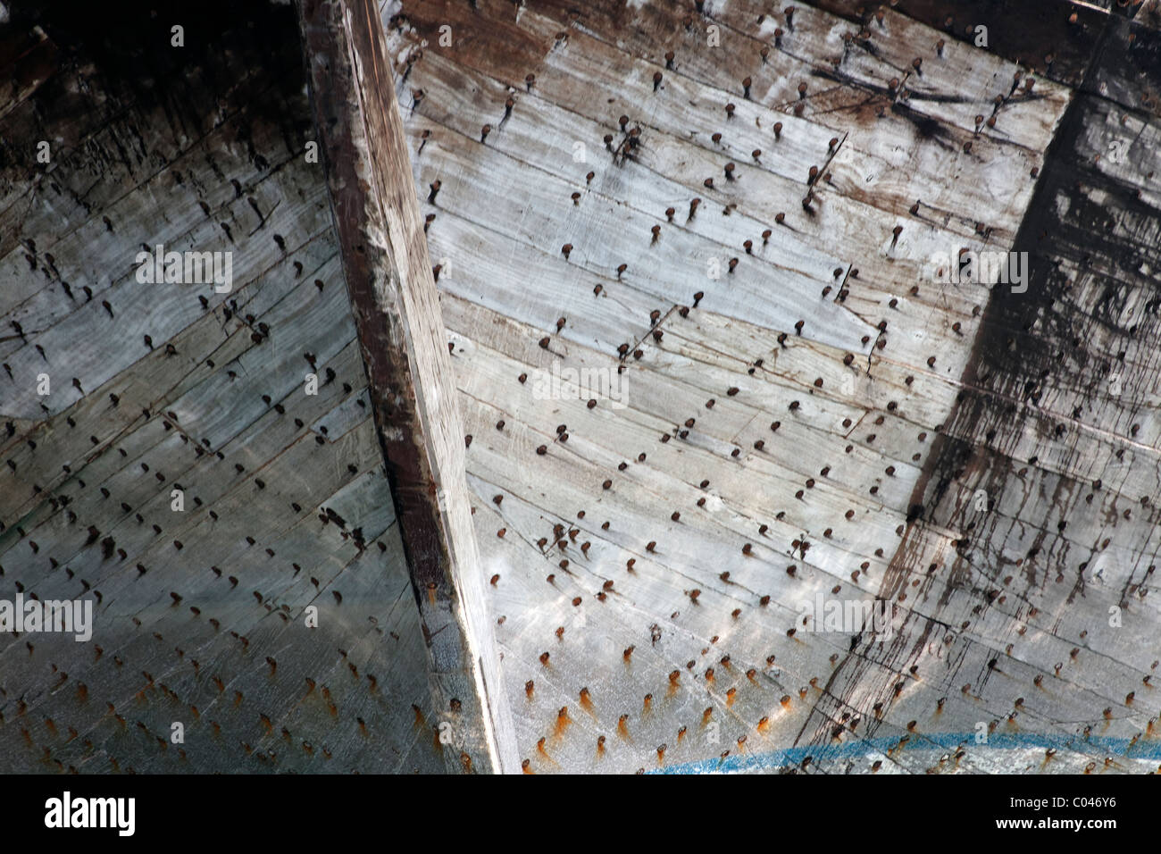The wooden hull of a traditional dhow moored on Dubai Creek (detail ...