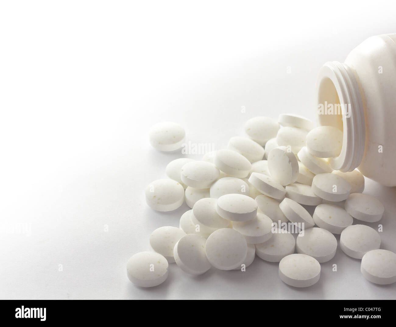 Round vitamins on white background Stock Photo - Alamy