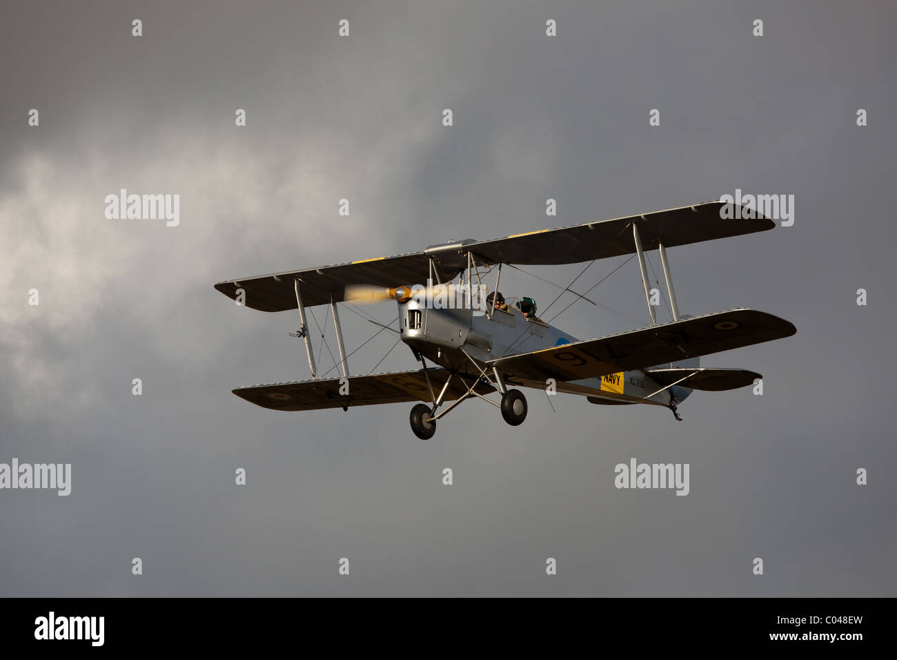 A vintage Tiger Moth biplane flying at Compton Abbas airfield in ...
