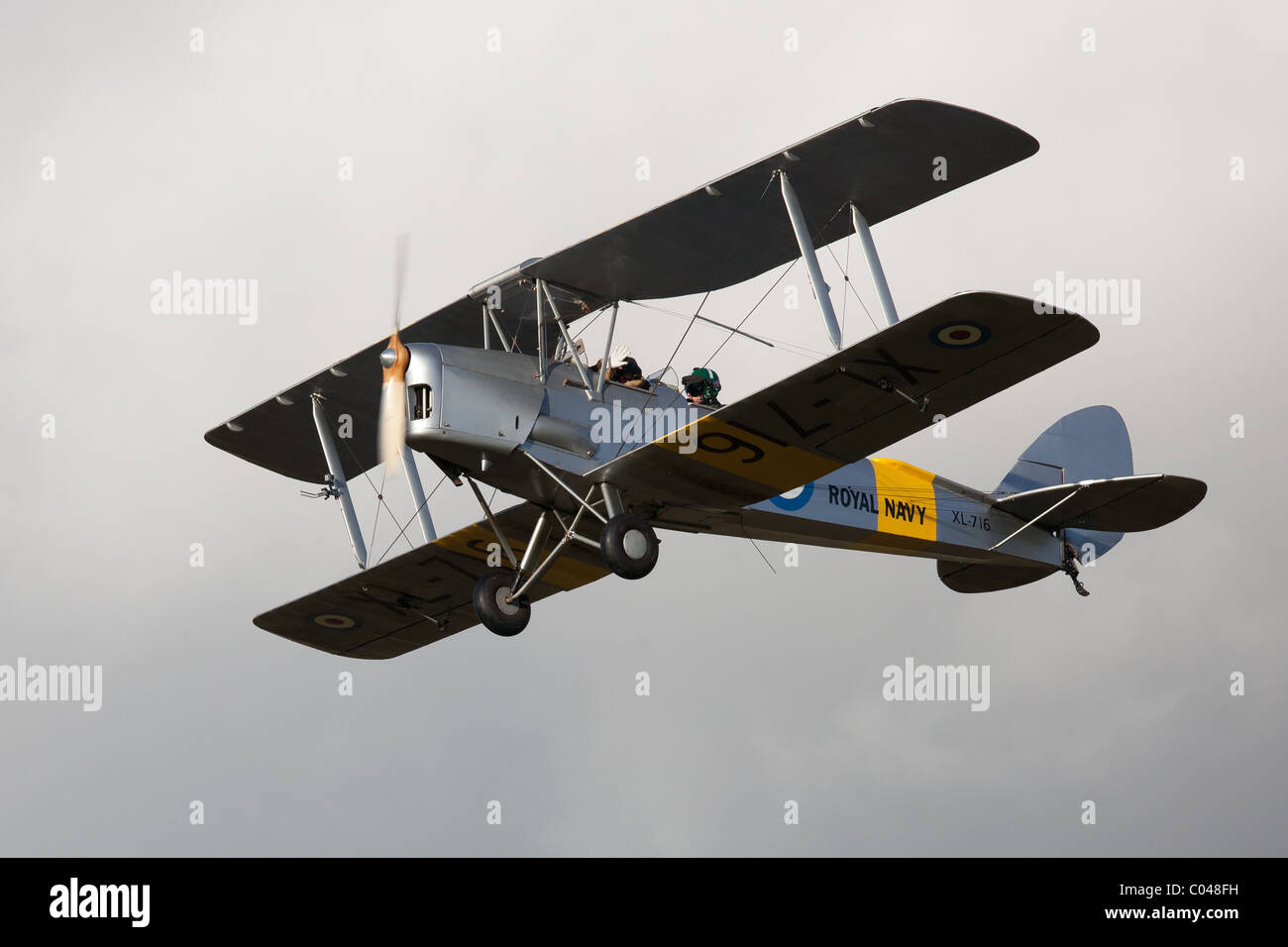 A vintage Tiger Moth biplane flying at Compton Abbas airfield in ...