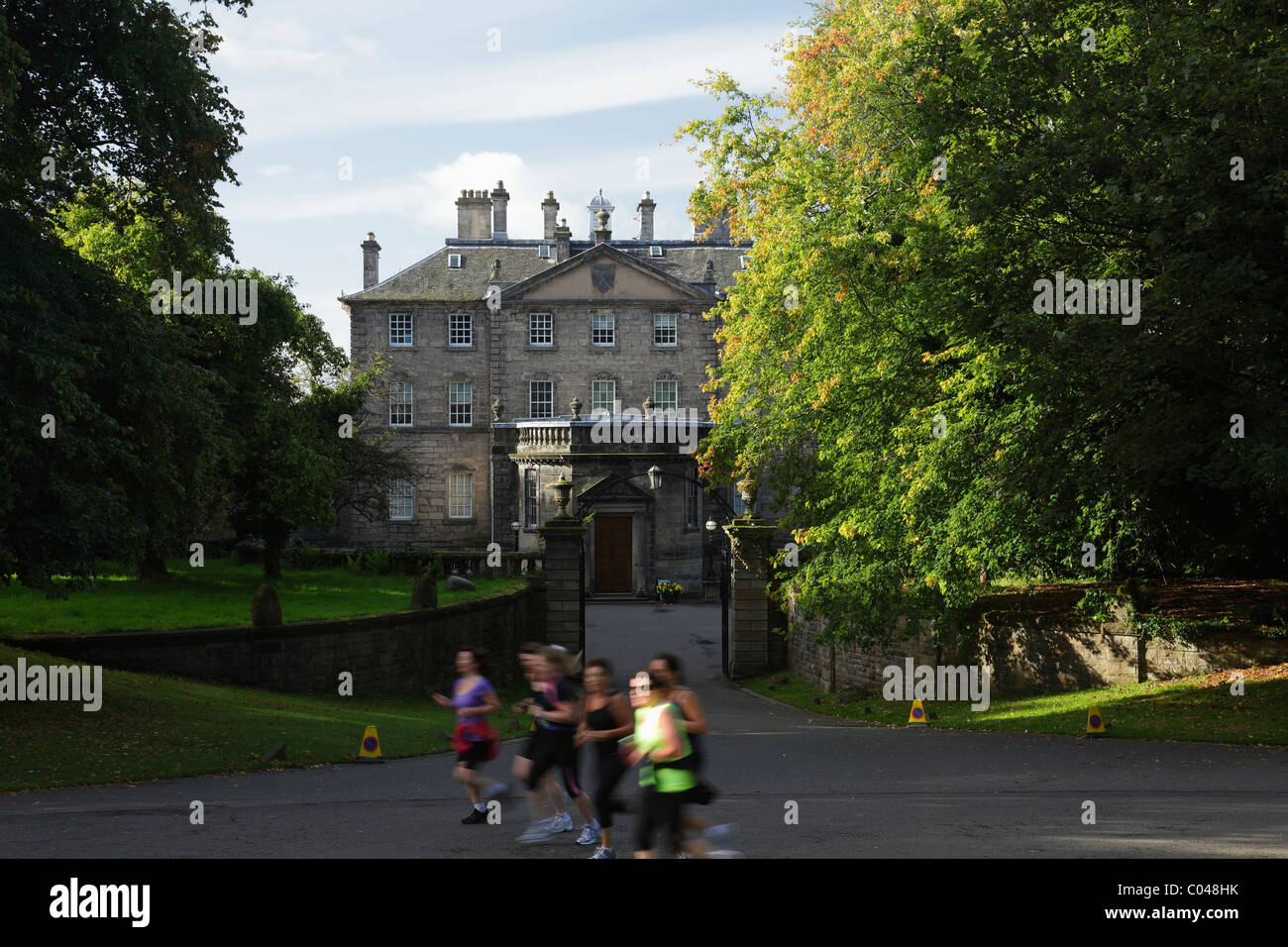 Joggers passing Pollok House run by the National Trust For Scotland in ...