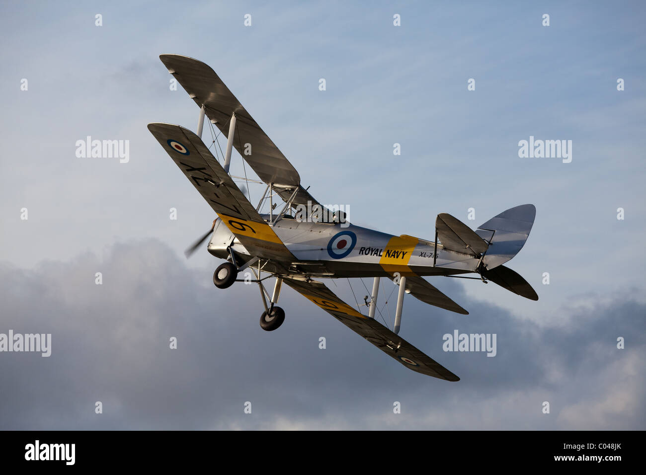 A vintage Tiger Moth biplane flying at Compton Abbas airfield in ...