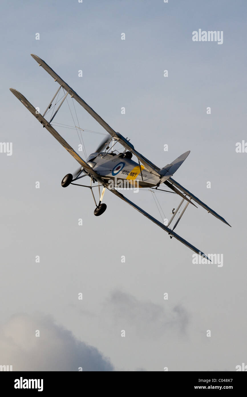 A vintage Tiger Moth biplane flying at Compton Abbas airfield in ...