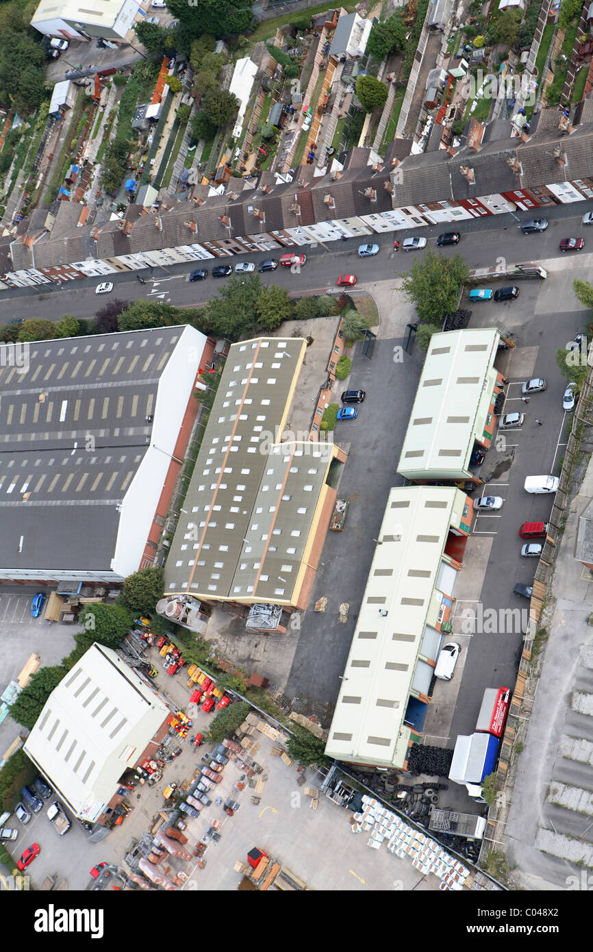 Terrace housing alongside industrial units Stock Photo - Alamy
