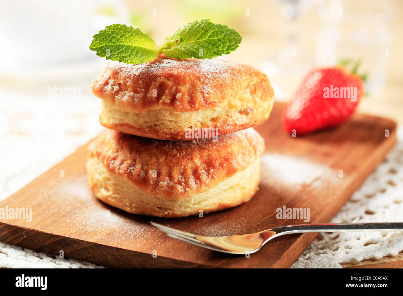 Two jam filled donuts on a cutting board Stock Photo - Alamy