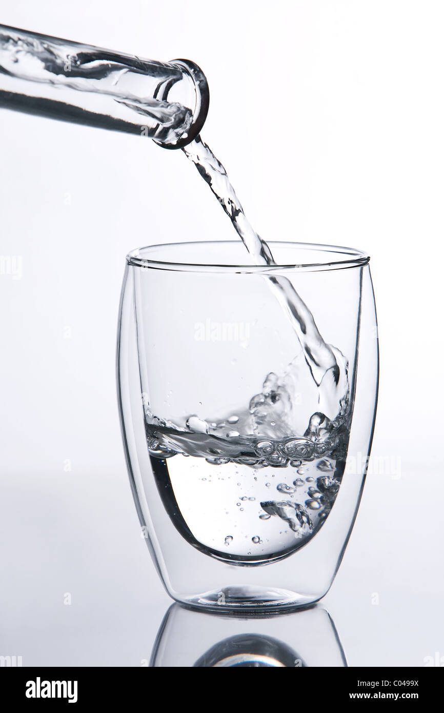 Shot of water falling into a glass Stock Photo - Alamy