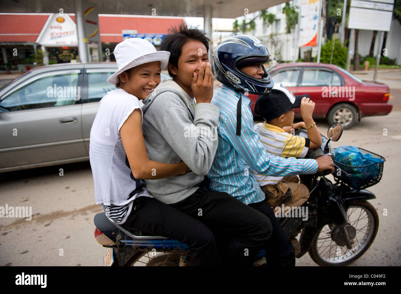 Four people on one motorbike hi-res stock photography and images - Alamy
