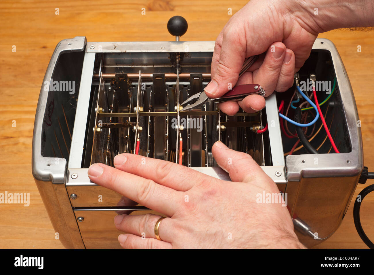 A MODEL RELEASED man mending a toaster in the Uk Stock Photo - Alamy