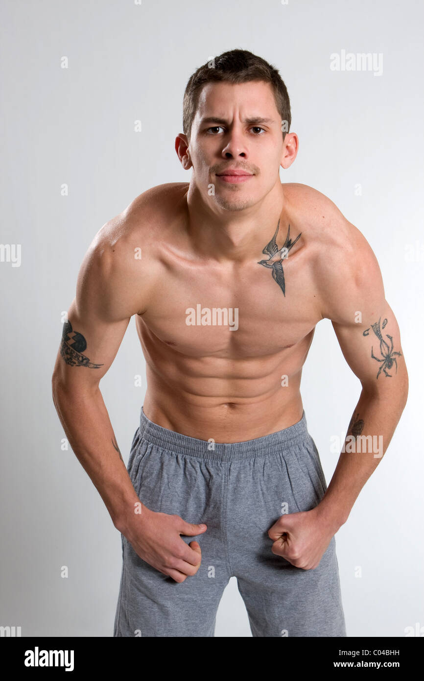 A young adult man flexing his muscles Stock Photo - Alamy